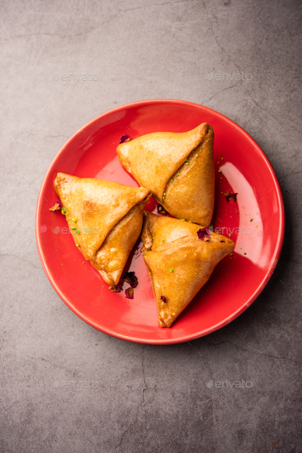Indian sweet samosa is a Fried pastry soaked in sugar syrup filled with ...