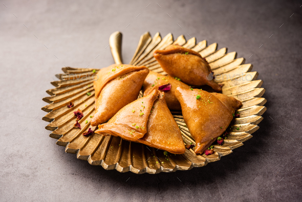 Indian sweet samosa is a Fried pastry soaked in sugar syrup filled with ...