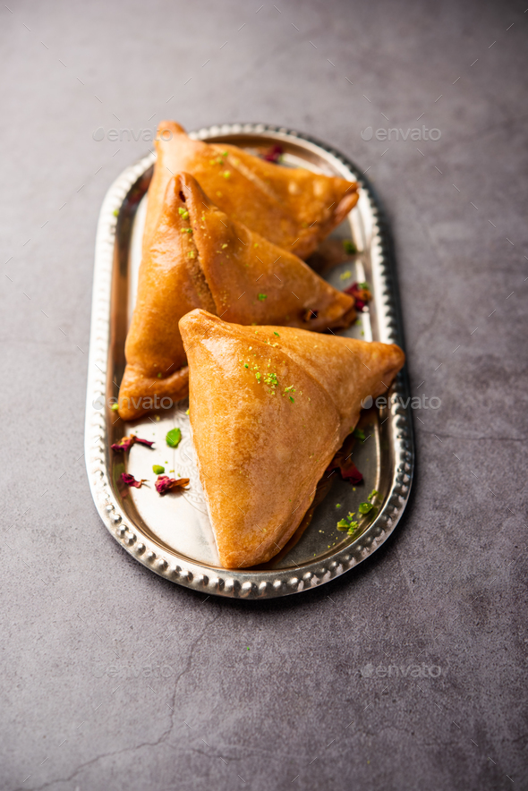 Indian sweet samosa is a Fried pastry soaked in sugar syrup filled with ...