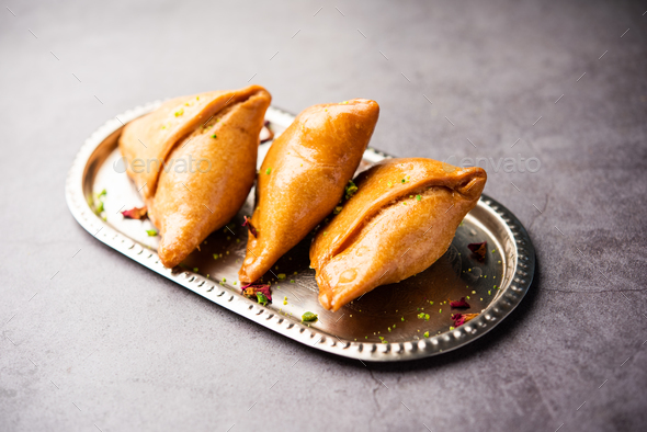 Indian sweet samosa is a Fried pastry soaked in sugar syrup filled with ...