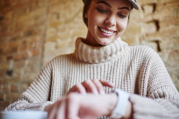 Positive woman tapping on smart watch Stock Photo by GaudiLab | PhotoDune