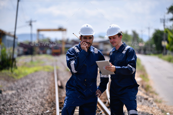 Engineer under inspection and checking construction process railway and ...