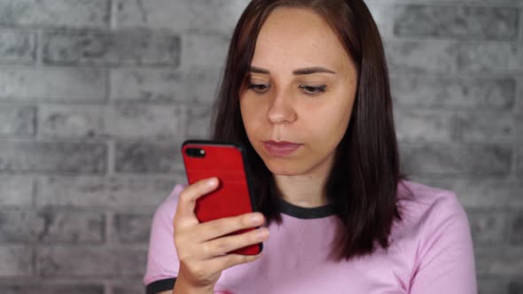 Young Woman Flipping Chat in Smartphone, Standing on Gray Brick ...