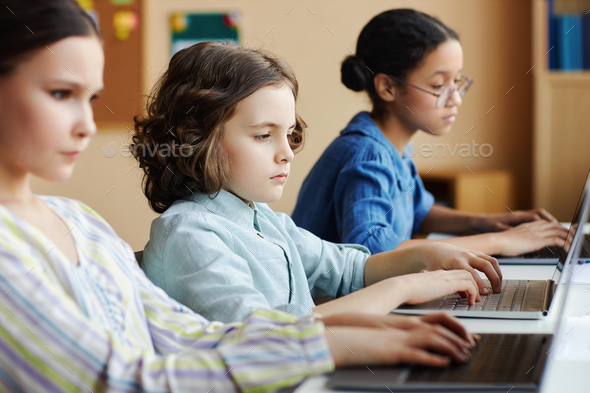 School children using computers in class Stock Photo by seventyfourimages