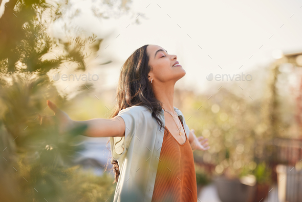 Serene latin woman enjoy sunset with gratitude Stock Photo by Rido81
