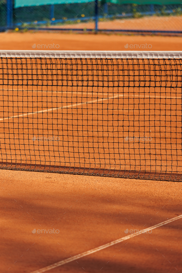tennis court made of red clay or soil with markings for game or ...