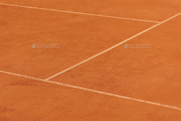 tennis court made of red clay or soil with markings for game or ...