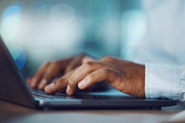 Closeup hands of african man working on a laptop. African american ...