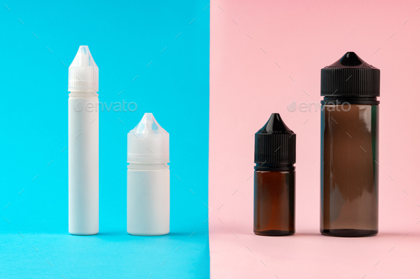 Vape bottles on pink and blue background Stock Photo by FabrikaPhoto