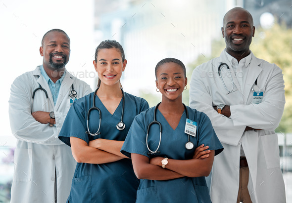 Group of happy doctors and nurses standing in a line with their arms ...