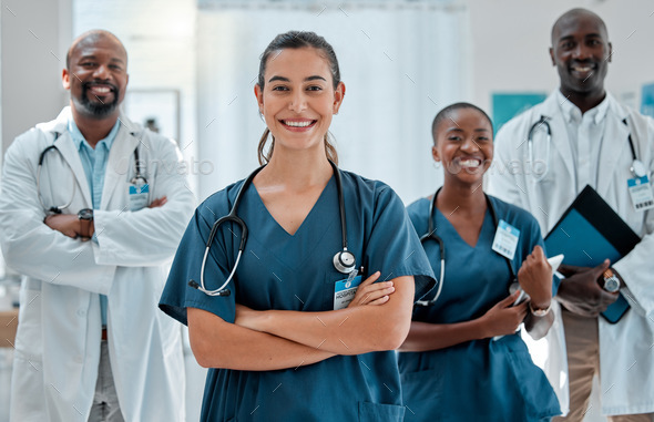 Group of happy diverse doctors standing with their arms crossed while ...