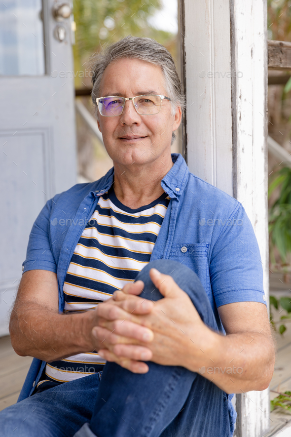 Portrait of cool caucasian senior man dressed in casuals sitting on ...