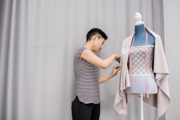 Modern female tailor designing new garment Stock Photo by Media_photos