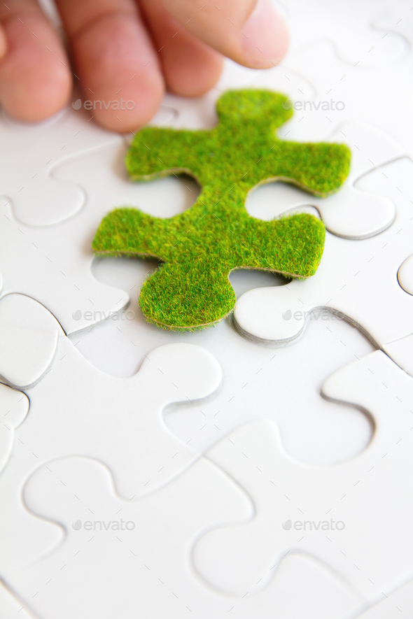 Hand holding a green puzzle piece, green space concept Stock Photo by ...