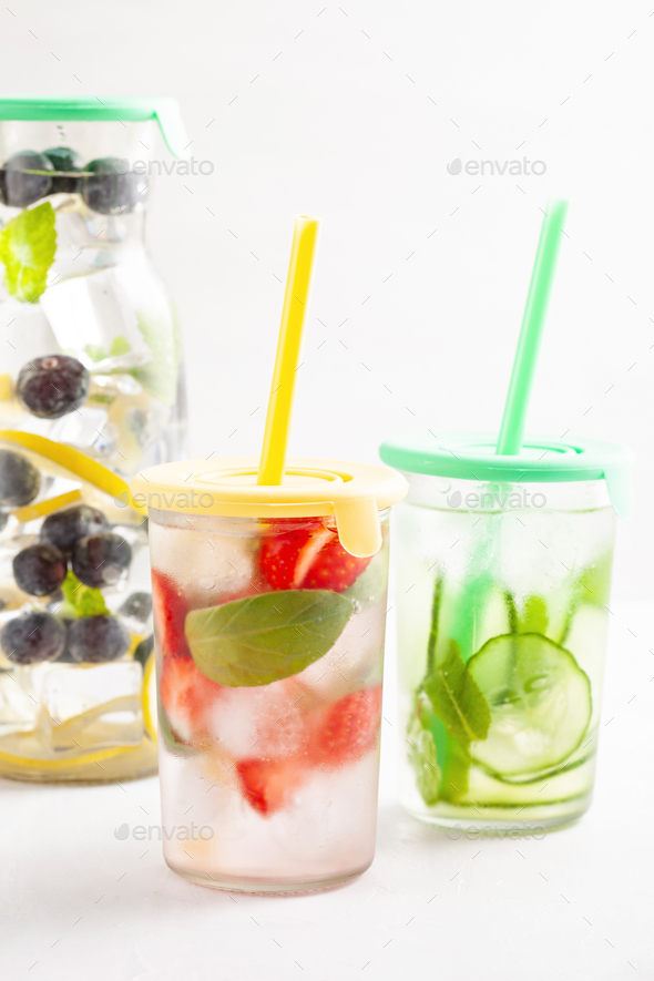 Herbs and fruits flavored infused water. Summer refreshing drink. Stock Photo by OksaLy
