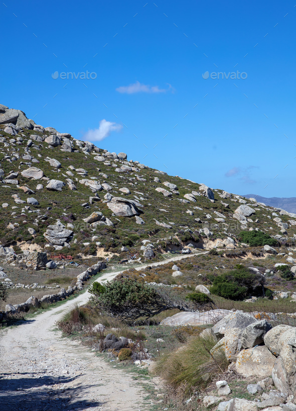 Rural path between granite volcanic rock. Volax village in Tinos island ...
