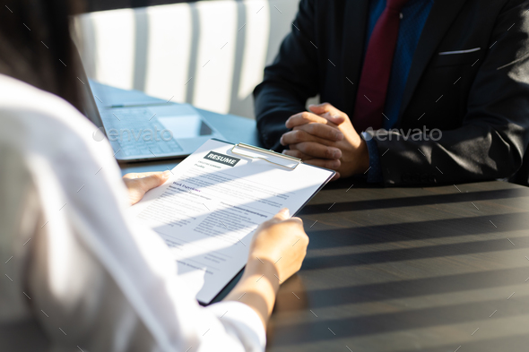 Employer in suit reading resume of job interview candidate profile ...