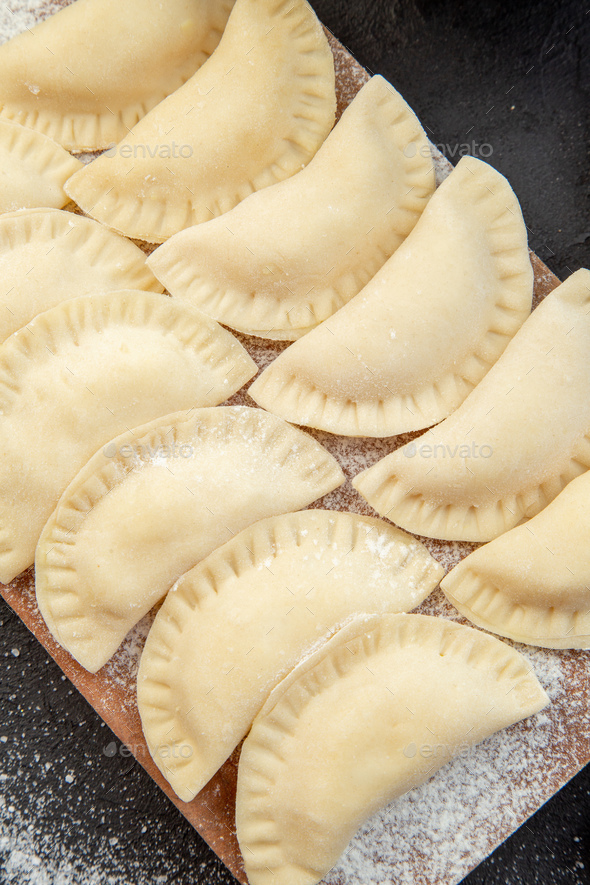 top view raw little hotcakes with flour mushed potatoes and eggs on ...
