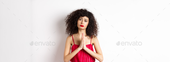 Lady with curly hair, wearing dress and begging for help, holding hands ...