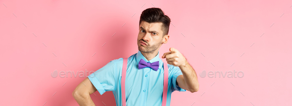 Grumpy guy in bow-tie and suspenders accusing you, its your fault ...