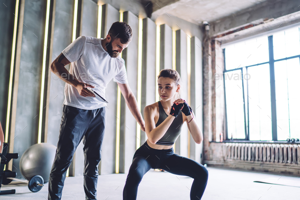 slim 20s woman with perfect figure working on lower body muscles with ...