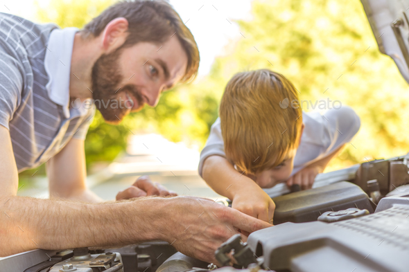 The boy and the father fixing a car Stock Photo by artemp3 | PhotoDune