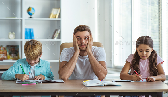 The angry father with kids doing homework at the desk Stock Photo by ...