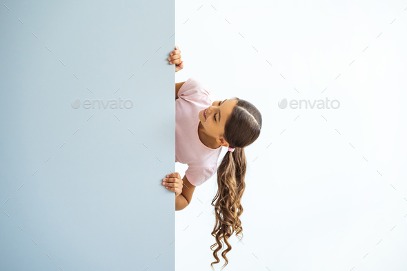 The little girl standing over the wall on white background Stock Photo ...