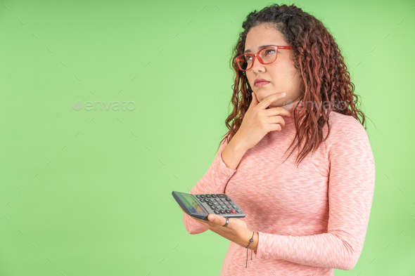 Young woman thinking how to do calculations with a calculator Stock ...