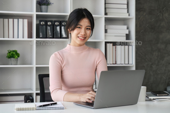 Beauitul young woman working using computer laptop smile looking at ...