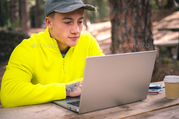 Portrait of beautiful caucasian boy influencer working on laptop ...