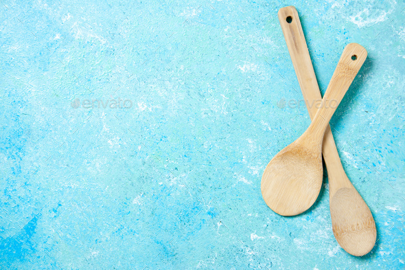 top view crossed wooden spoons on blue background with free place Stock ...