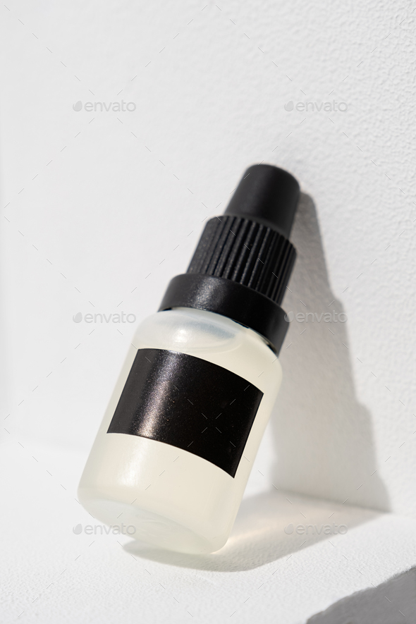 Set of plastic dropper bottles with liquid with black blank stickers ...