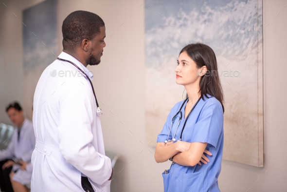 doctors talking in corridor at medical clinic, talking. Stock Photo by ...