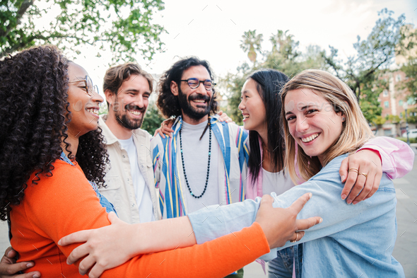 Group of happy people hugging each others on a circle. On foreground ...