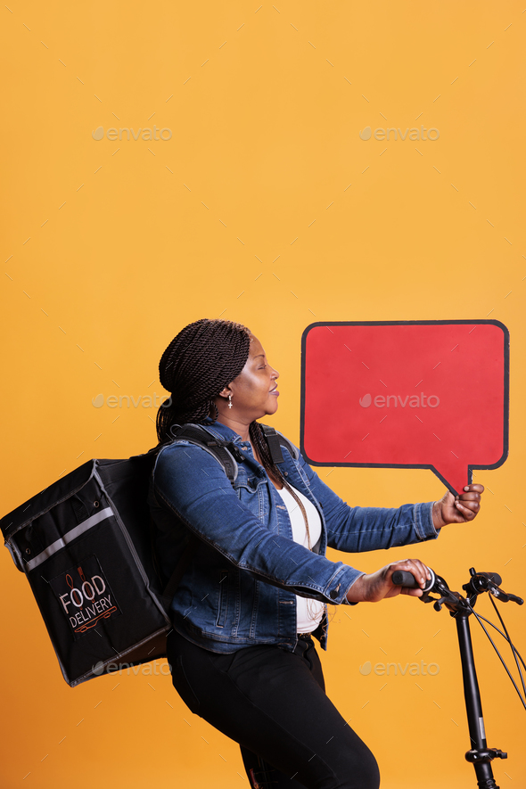 Pizzeria employee carrying takeaway thermal backpack while riding ...