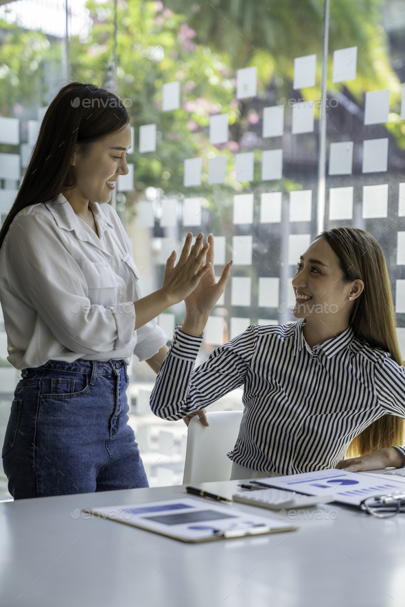 Asian Businesswoman clapping hands high five in modern white office ...