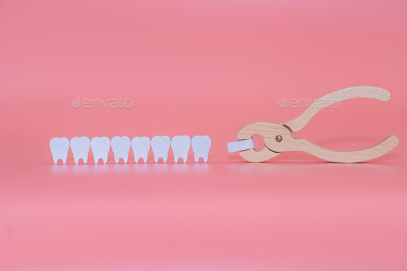 Teeth row and forceps for tooth extraction. Oral health problems and ...