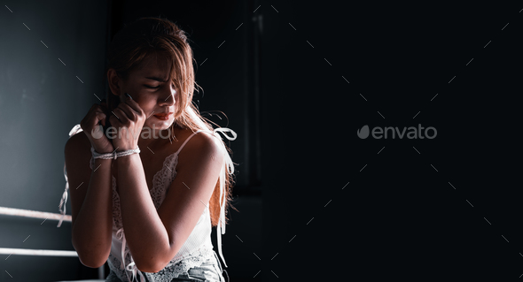 Asian female hands bound with ropes and confined in a dark room Stock ...