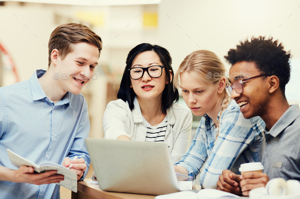 Asian girl showing presentation to group mates Stock Photo by Media_photos