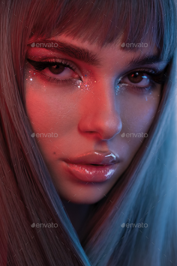 High fashion model face woman in colorful bright neon UV blue and red ...