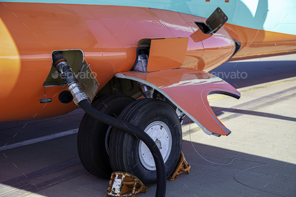 Refueling the plane at the airport. Gas tank hatch. Fuel tank. Copy ...