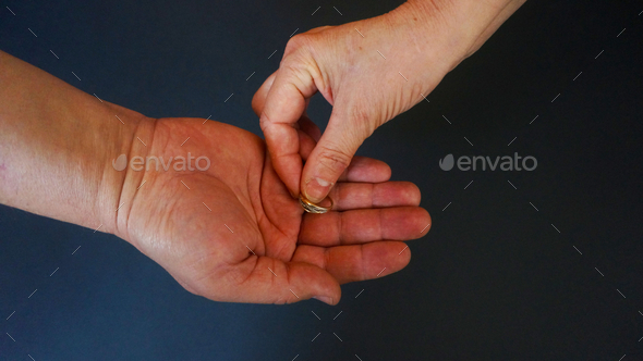 Hand of an old woman giving her wedding ring back to her husband - old ...