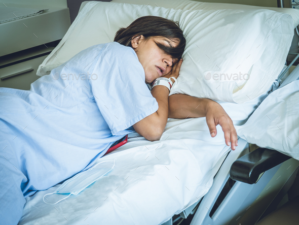 Closeup shot of a caucasian female patient laying on a hospital bed ...