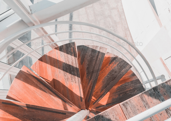 Top view of a round wooden staircase with white railings Stock Photo by ...