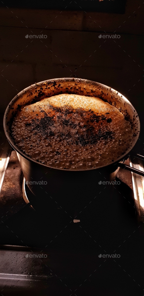 Vertical closeup shot of the sunlight falling while making Indian tea ...
