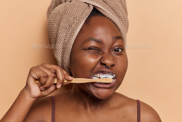 Dark skinned obese woman promoting confident and radiant smile brushes ...
