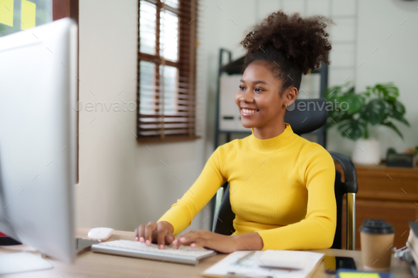 Beautiful young black woman working with laptop computer at home. Stock ...