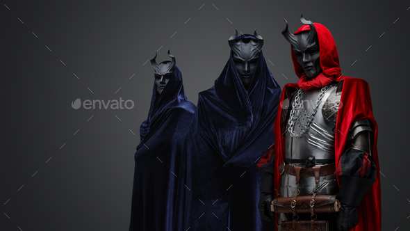 Two cultists in blue robes and their leader in red Stock Photo by fxquadro