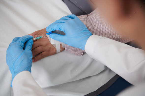 Doctor Inserting Intravenous Catheter Stock Photo by DragonImages ... Doctor Inserting Intravenous Catheter Stock Photo by DragonImages ...